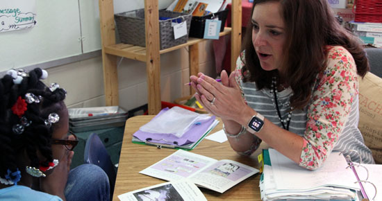 Image of Mary Huelsman working with a student