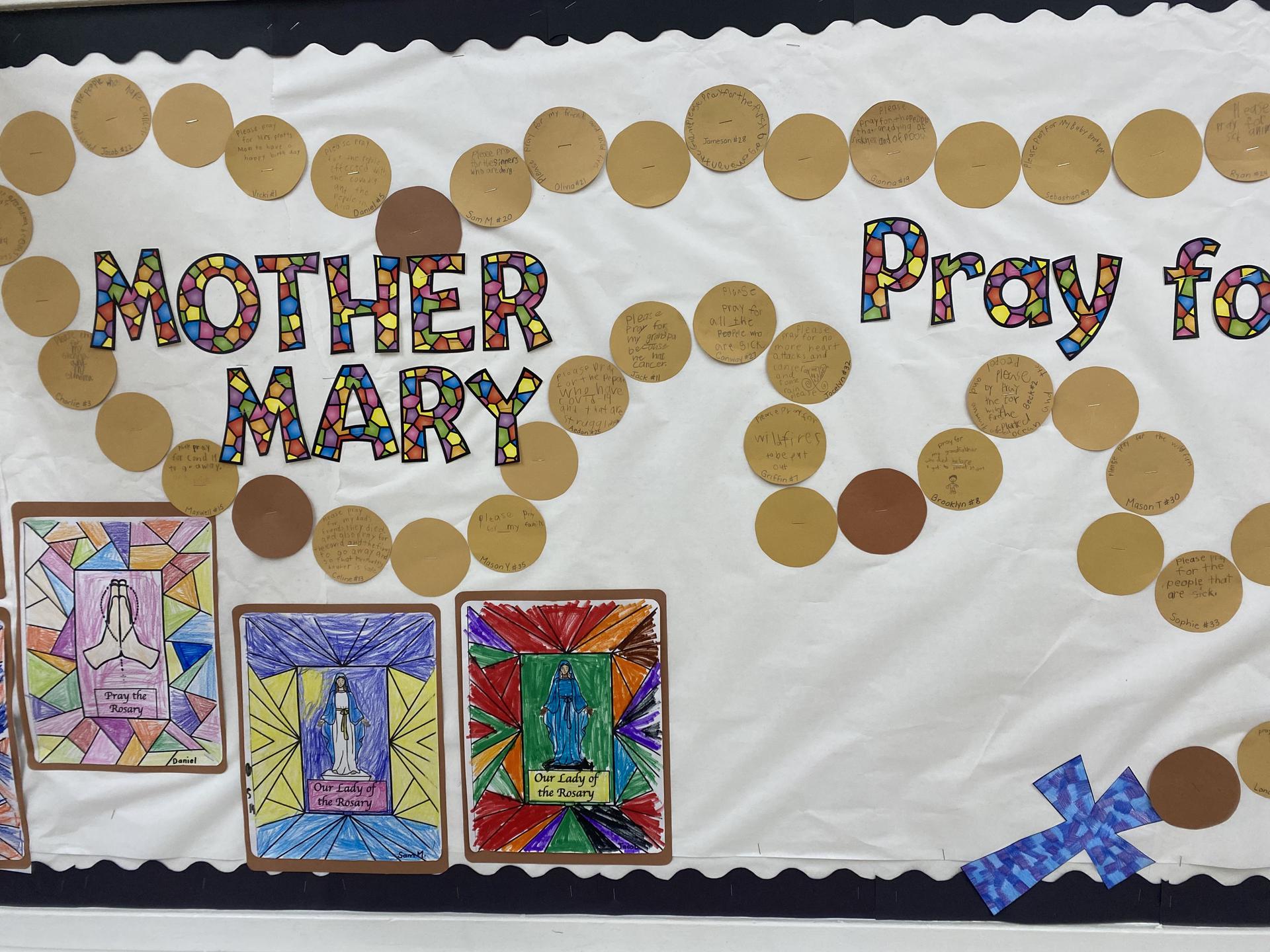 2nd grade students write prayers on the paper rosary beads